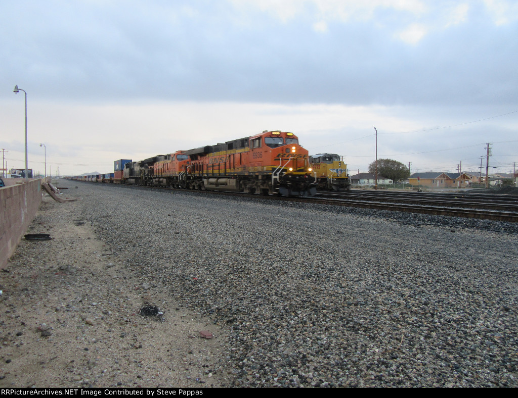 BNSF 6936 leads a train through the yard
